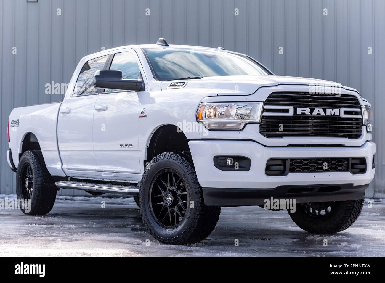 A white Dodge Ram truck parked on a concrete surface in a natural ...