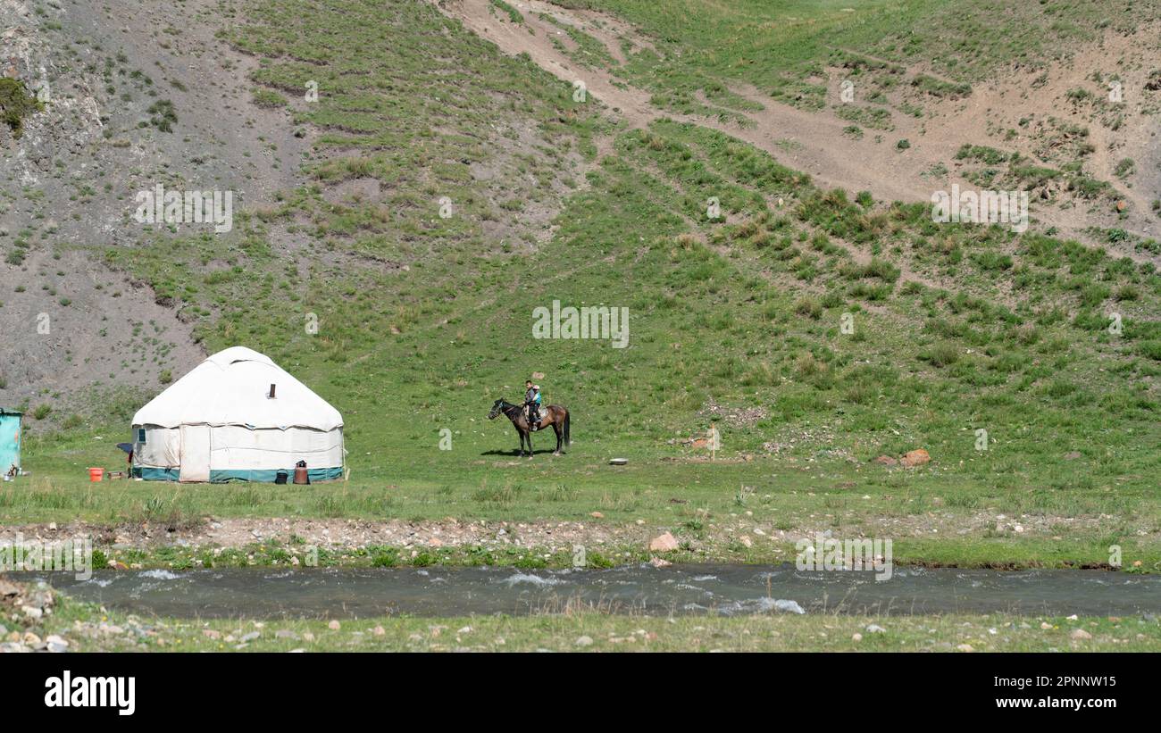 Kyrgzystan - May 2022: Kids near a traditional Yurt tent in Kyrgyzstan ...