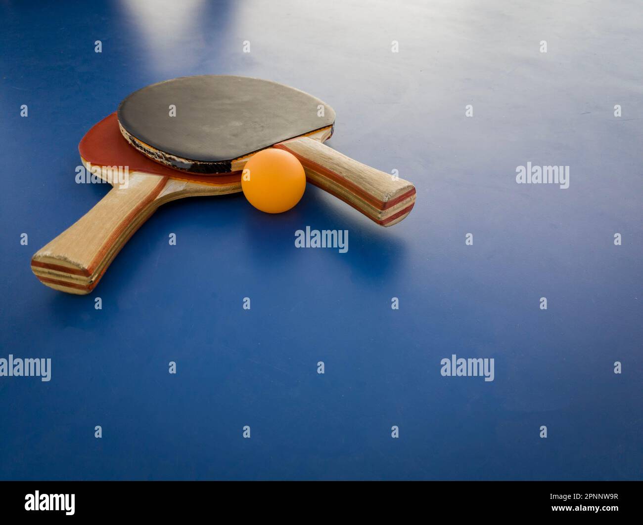 An Image Of A Ping Pong Paddle And Ball Resting On A Vibrant Blue