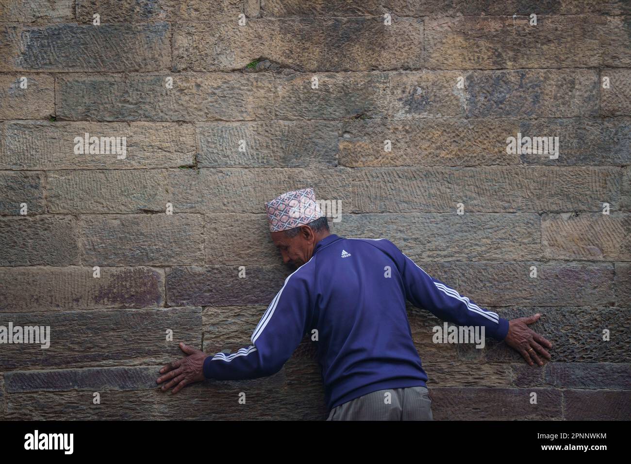A Hindu devotee makes his way back through a narrow ledge on the banks ...