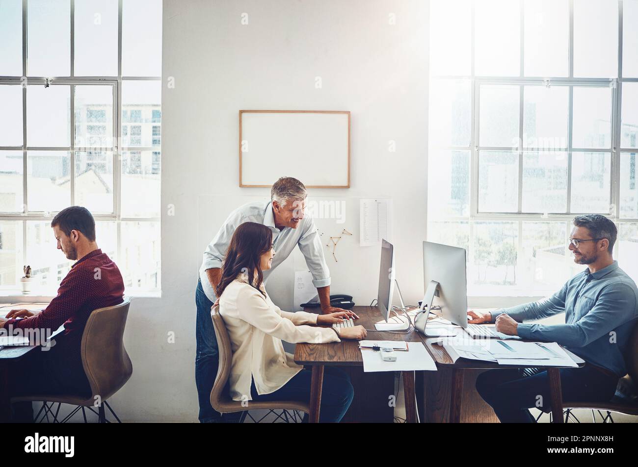 Ready to help is younger colleagues. a group of colleagues working in ...