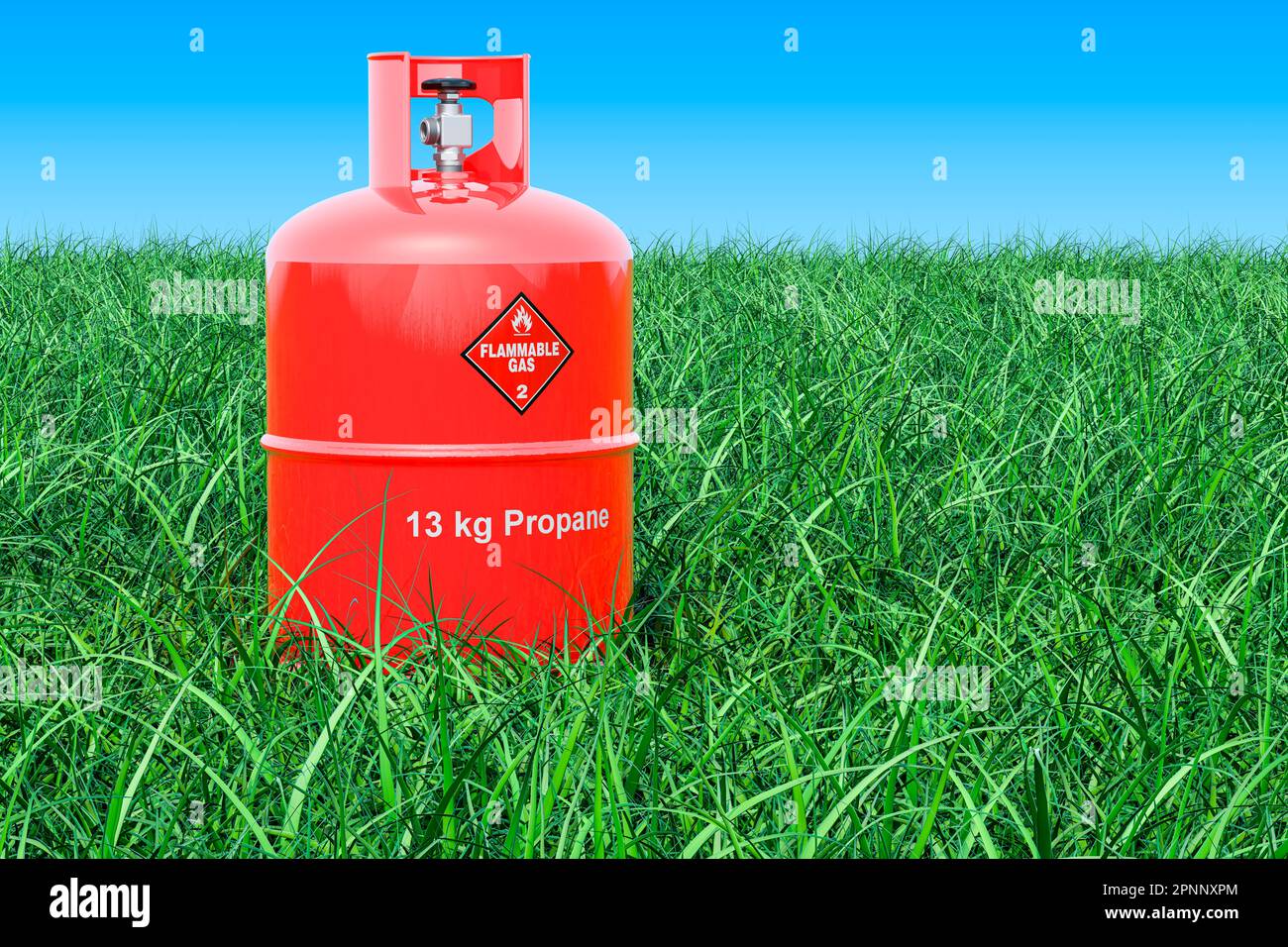 Propane cylinder with compressed gas on the green grass against blue ...