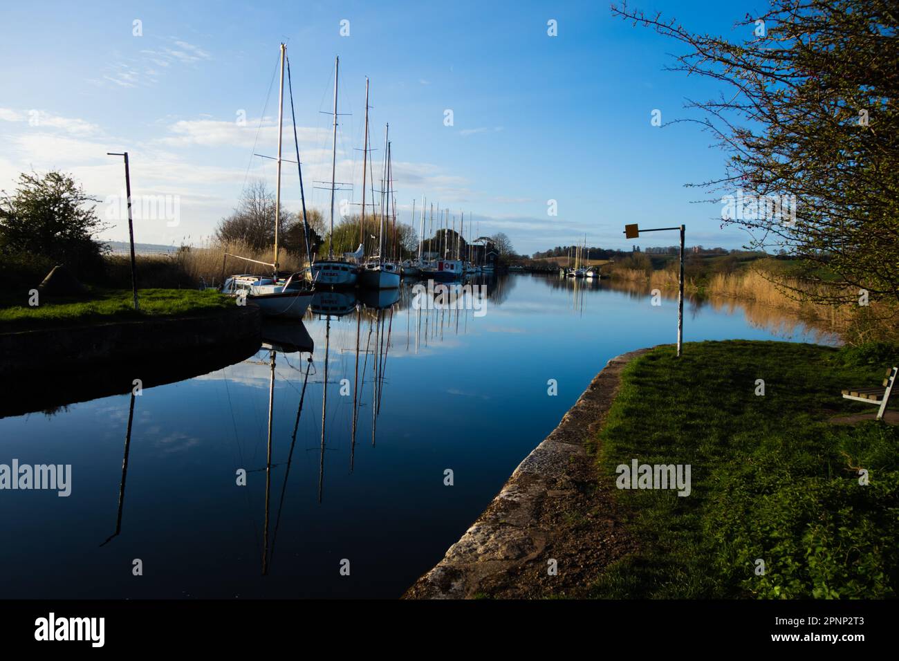 the Exeter Ship Canal at Topsham with a few clouds and distant boats ...