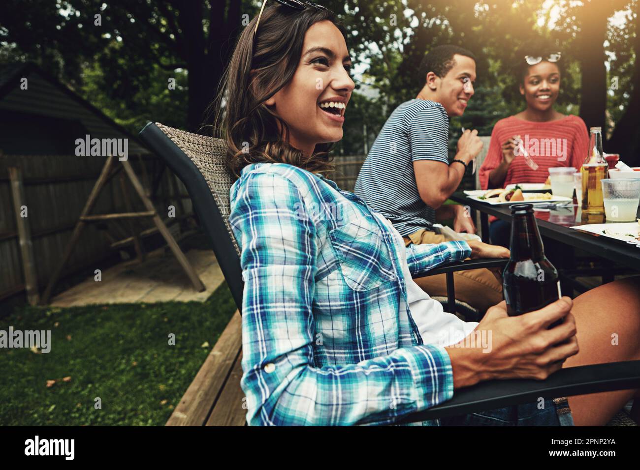 Good fun with good company. a group of friends having a barbecue in the ...