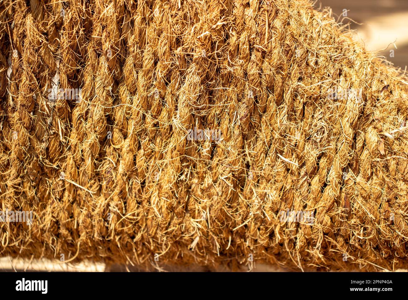 orange rope wound round wood texture Stock Photo - Alamy