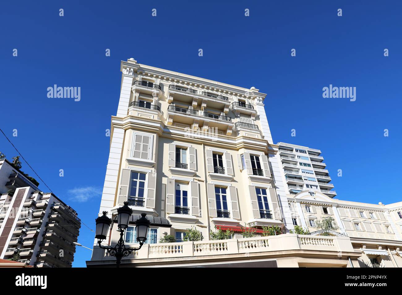 Low-angle view of a white, luxurious residential building in Monte ...