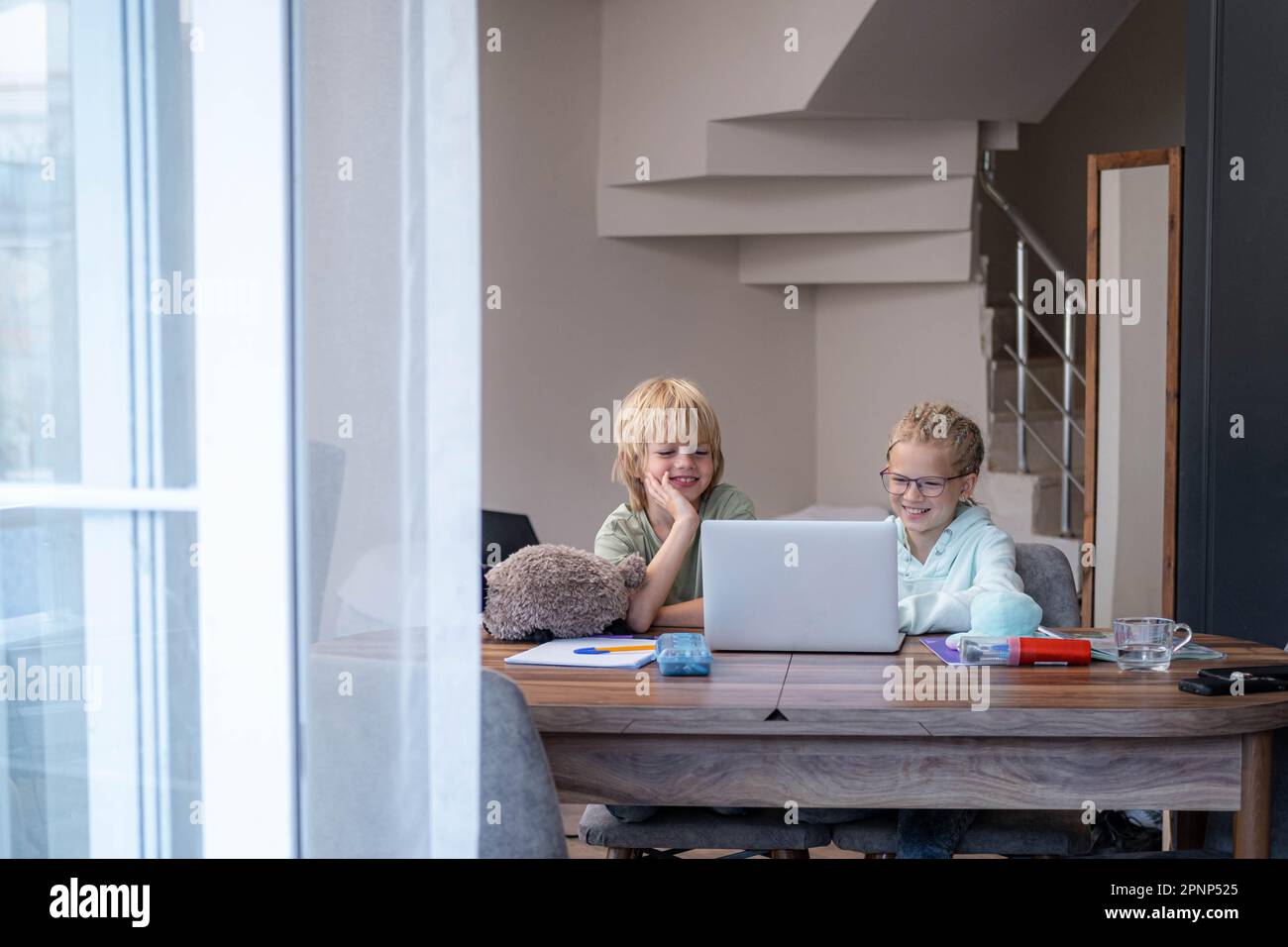 Online school class, siblings pupils boy and girl learning together ...