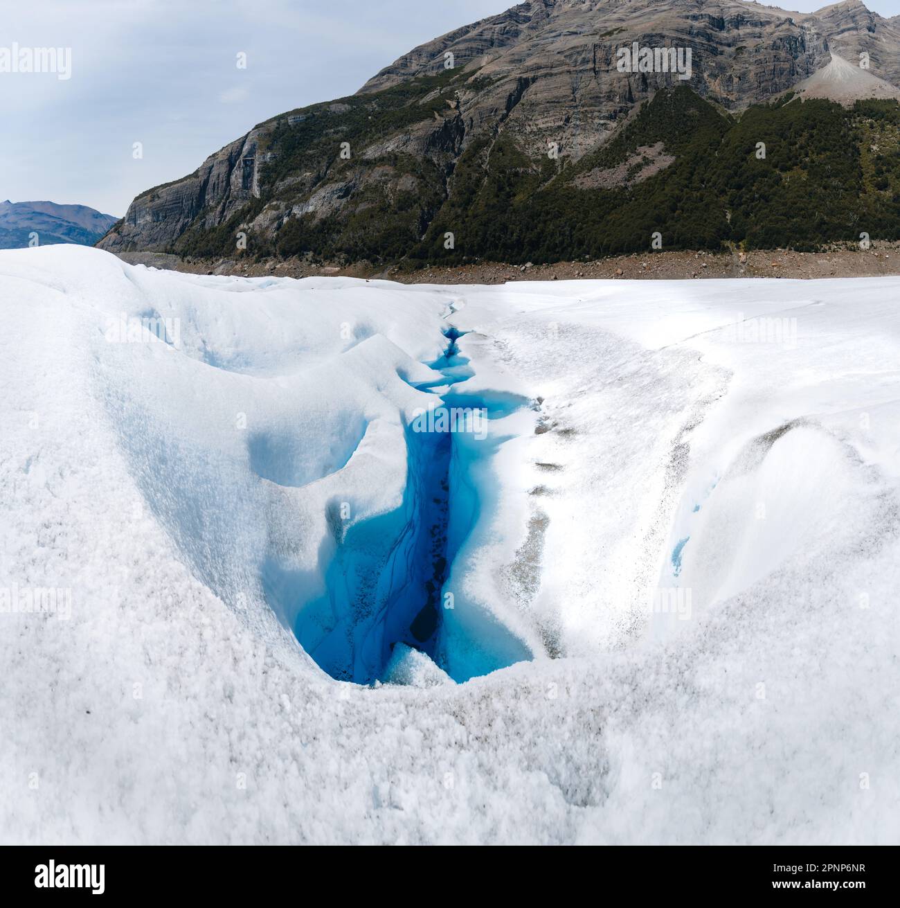 Beautiful glaciers flow through the mountains. Close up blue glacier ...