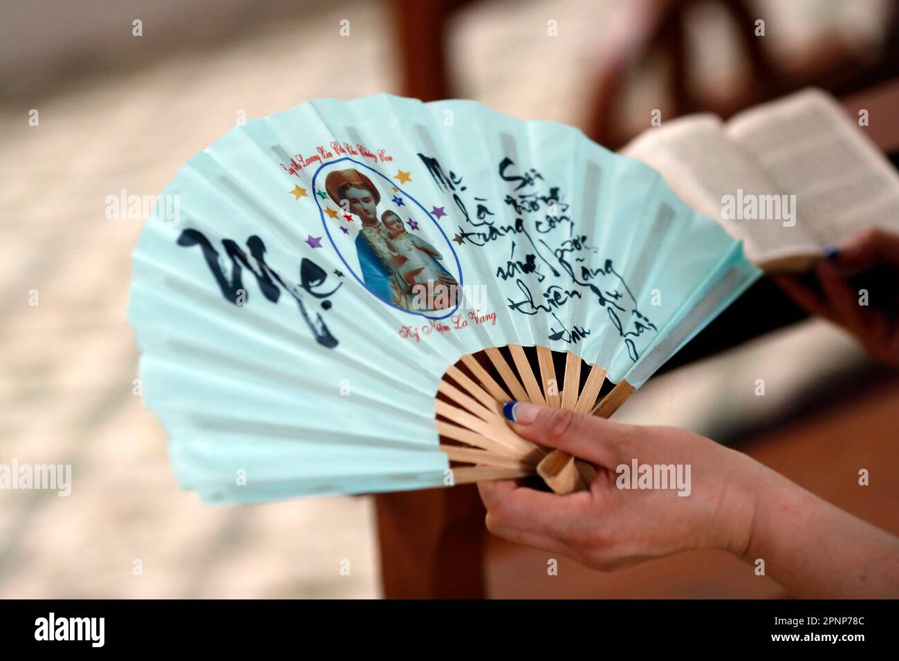 Catholic church. Woman holding a Virgin Mary fan. Tan Chau. Vietnam ...
