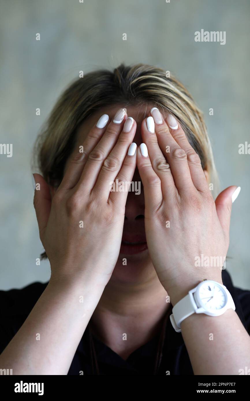 Anxiety and depression. Sad young woman in pain crying and covering her ...