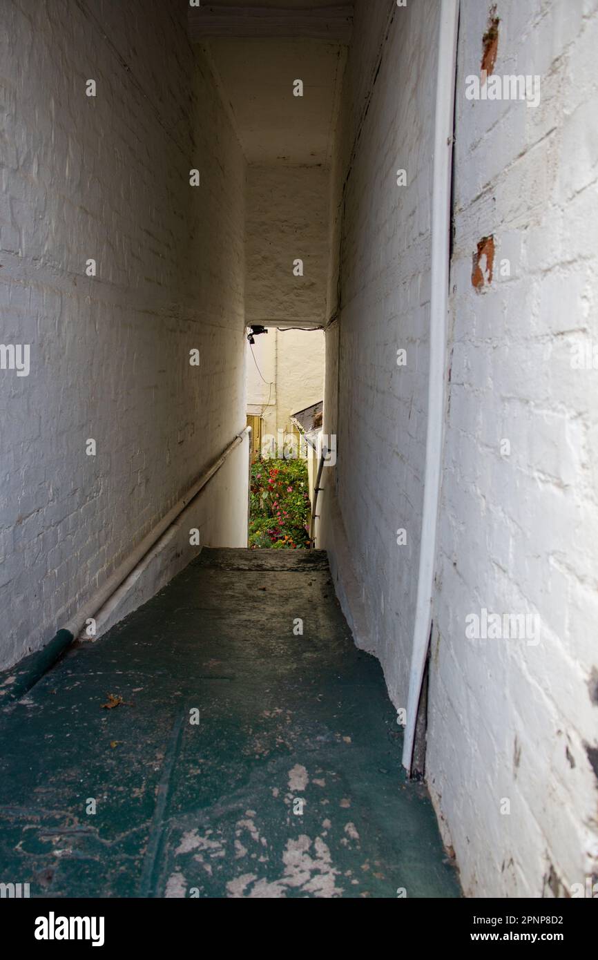 white painted narrow passageway between buildings with a handrail Stock ...