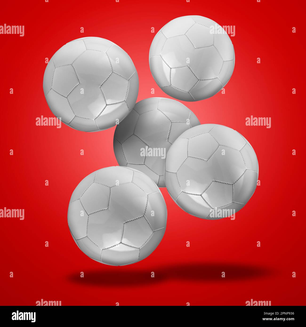 Floating leather Soccer balls against red radial gradient background ...