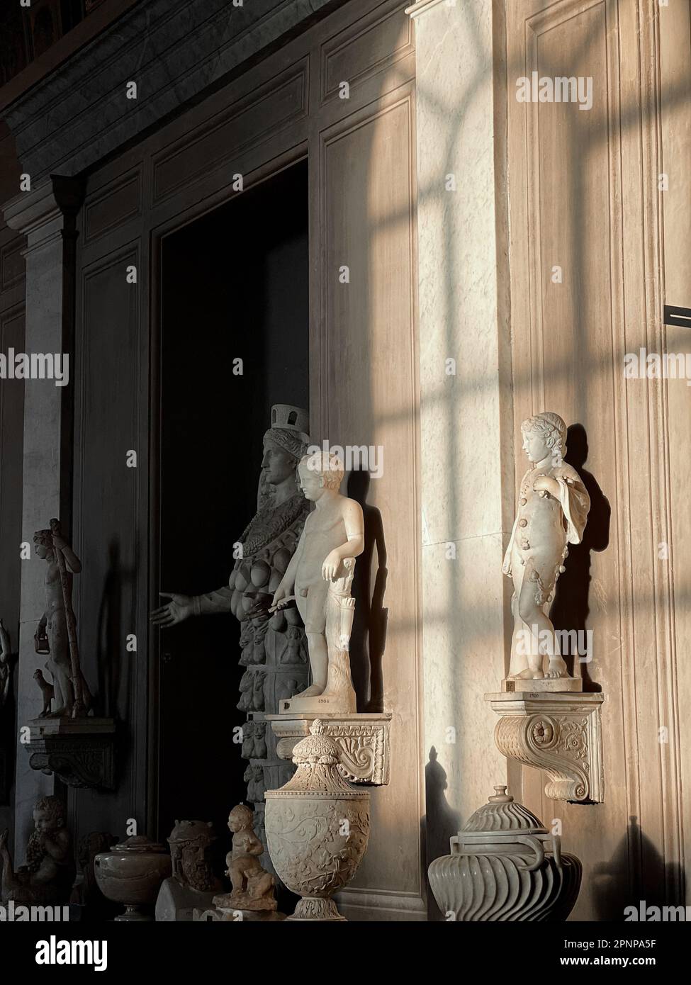 A vertical shot of ancient statues situated in an outdoor environment ...