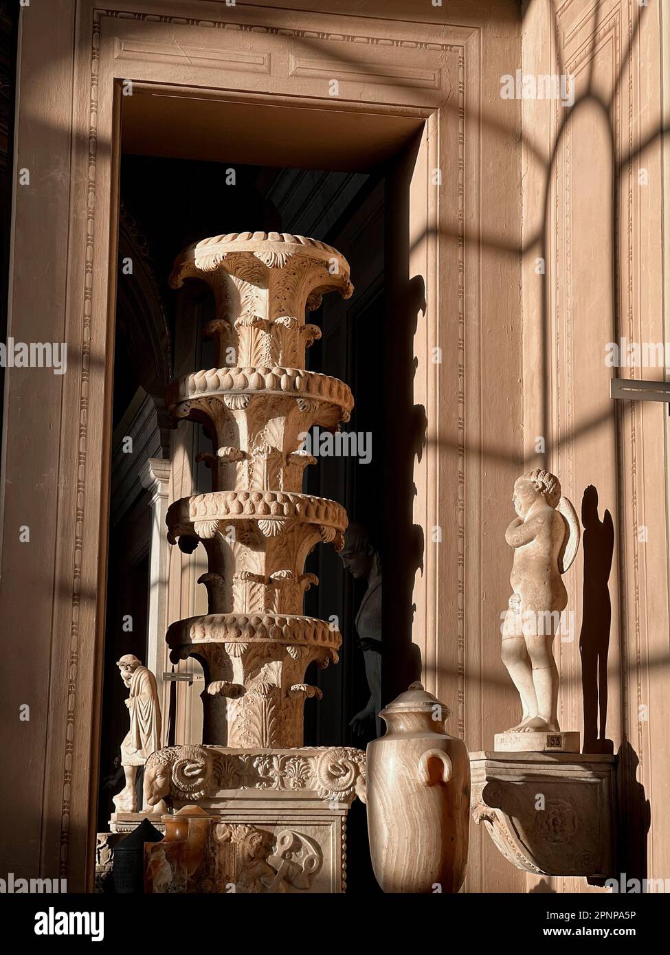 A vertical image featuring ancient statues standing side-by-side in an ...