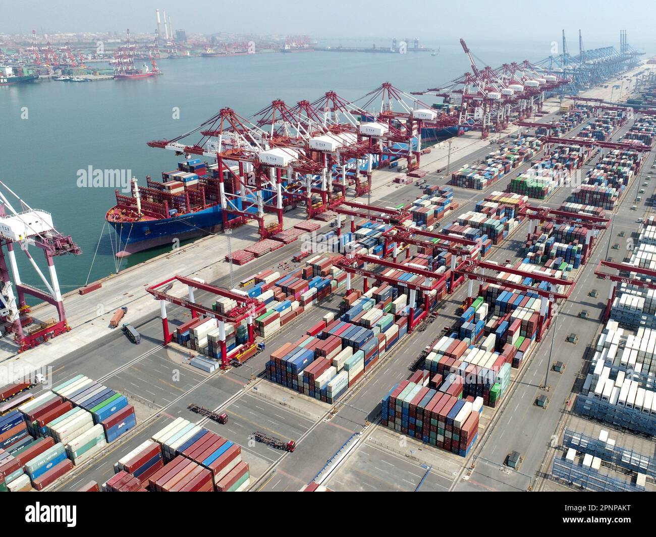 QINGDAO, CHINA - APRIL 20, 2023 - Cargo ships load and unload cargo at ...
