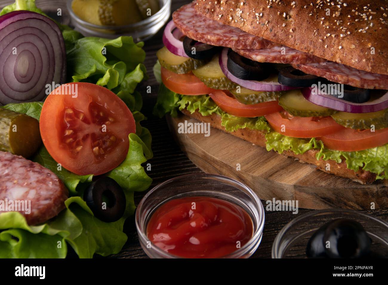 photo of lots of food to cook and a salami sandwich in close-up Stock ...