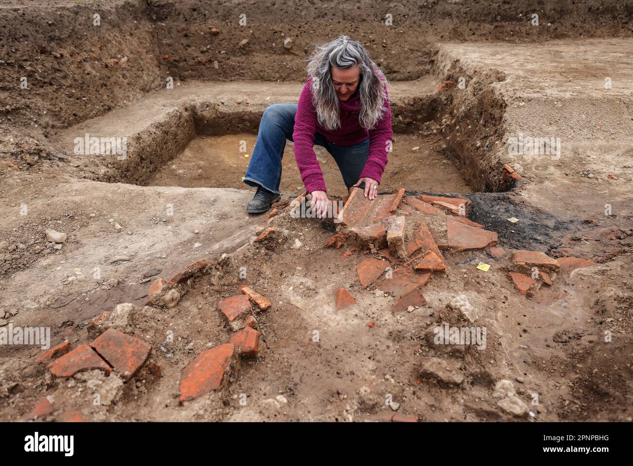 Xanten, Germany. 20th Apr, 2023. An archaeologist uncovers roof tiles ...