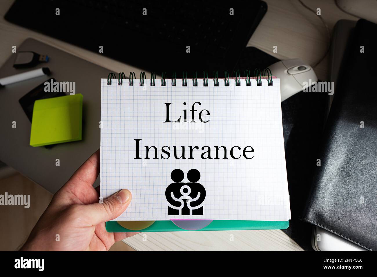Life insurance word on notebook holding man against desktop Stock Photo ...