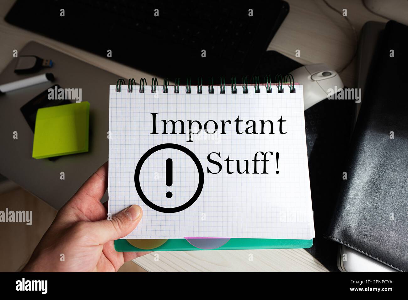 Important stuff word on notebook holding man against desktop Stock ...