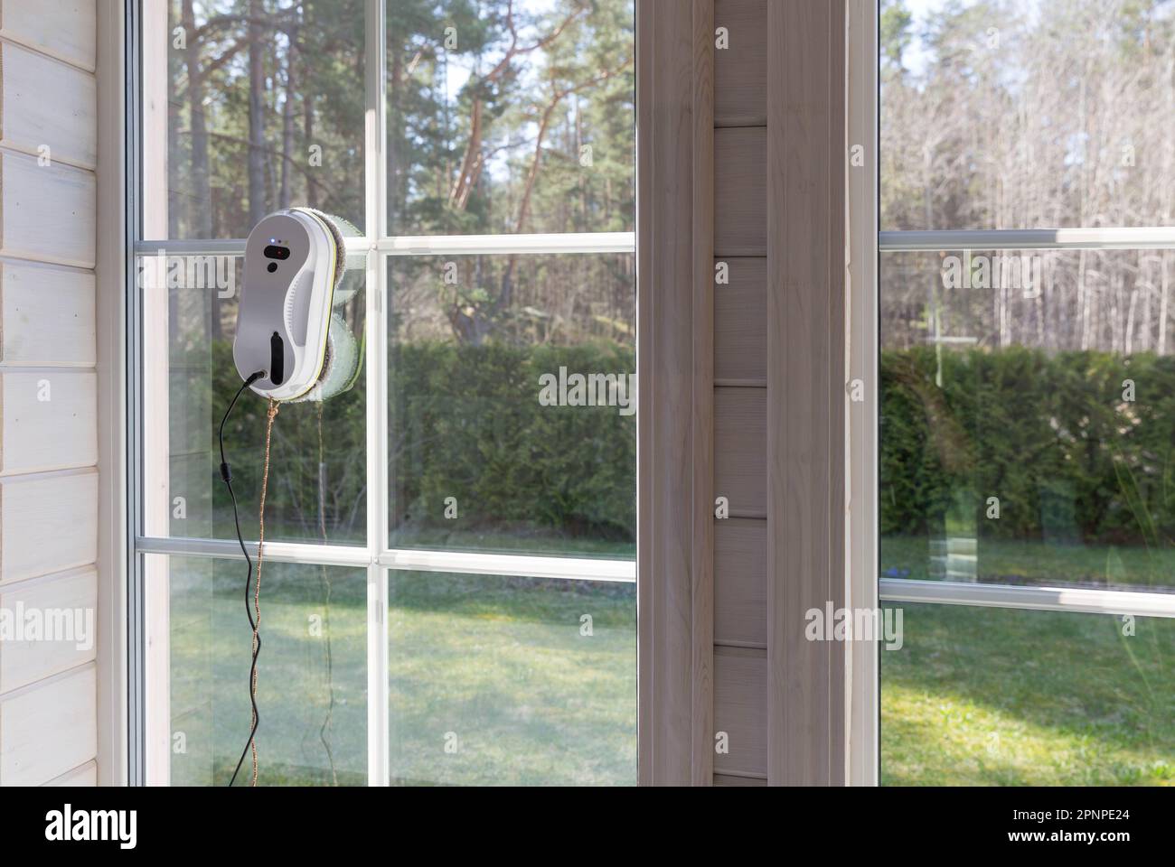 Window cleaning robot. Washing glass using technology in a modern home ...
