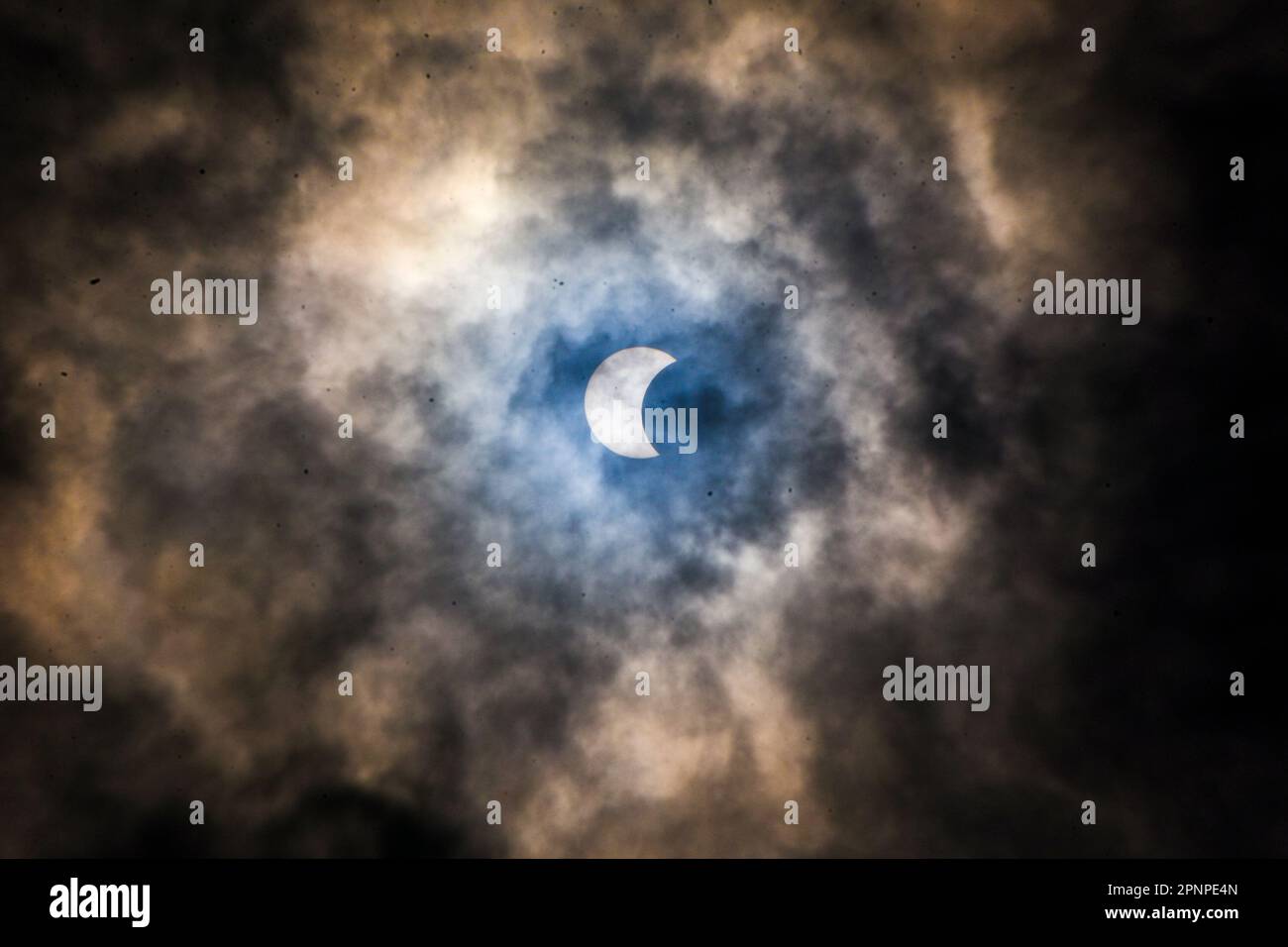 A general view shows a hybrid partial solar eclipse in Jakarta ...