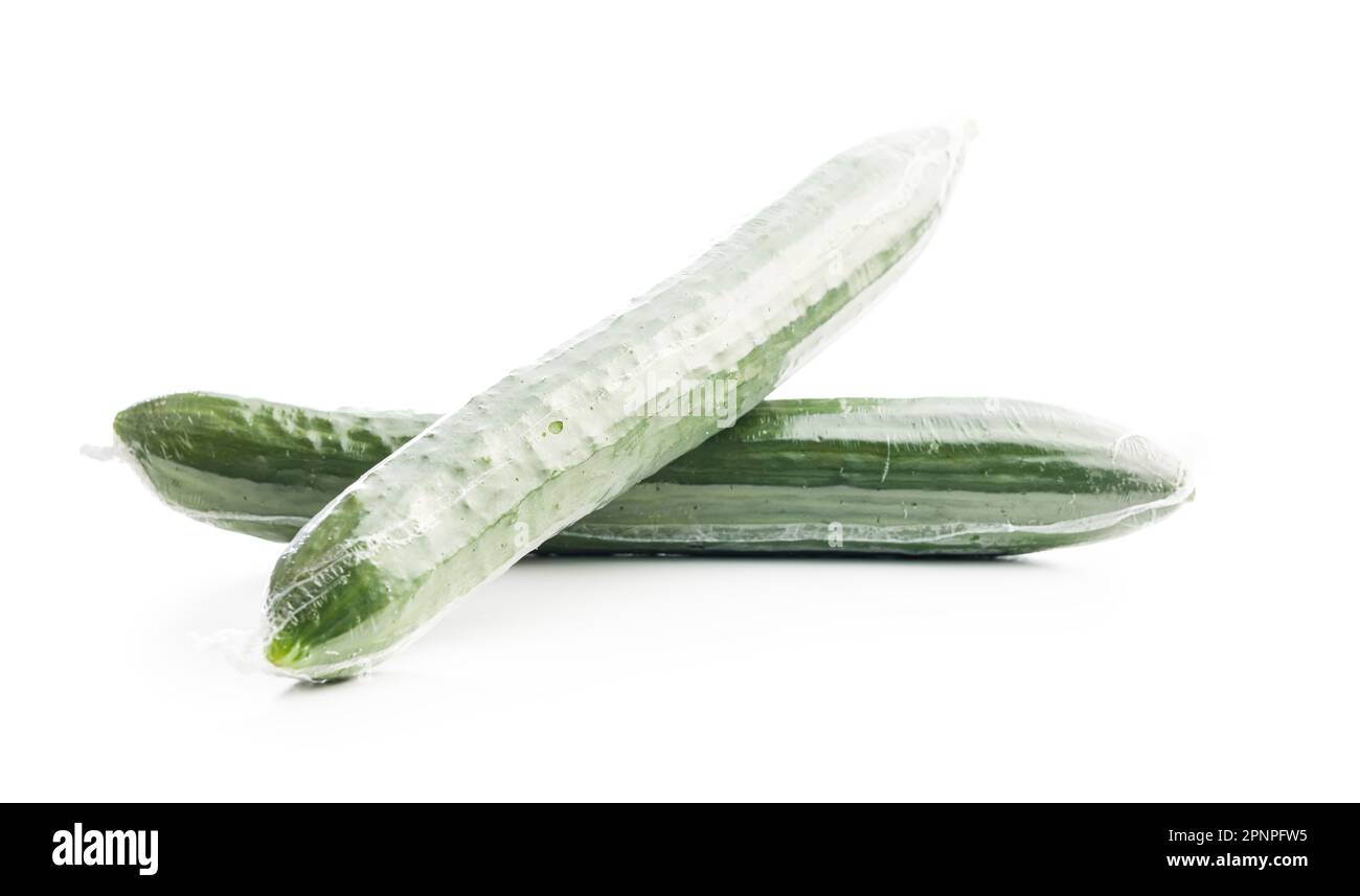 Fresh green cucumbers wrapped in plastic wrap isolated on the white ...