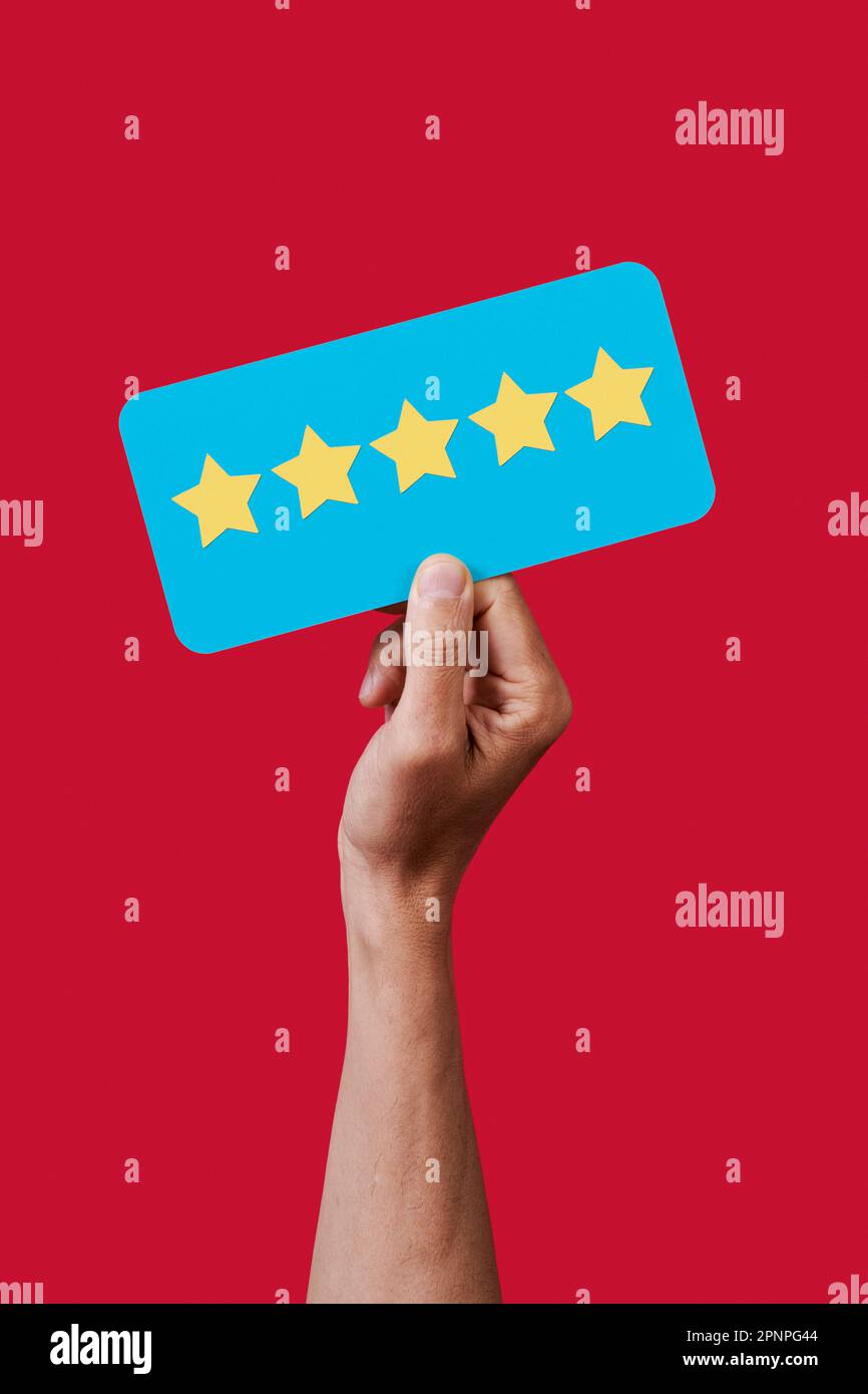closeup of the hand of a man holding a blue sign with five stars, from ...