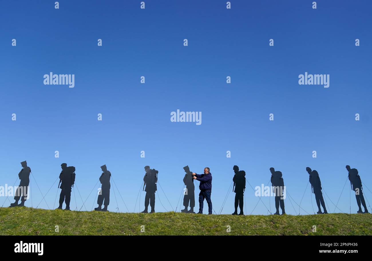 Dan Barton, creator of Standing with Giants, adjusts a silhouette which ...