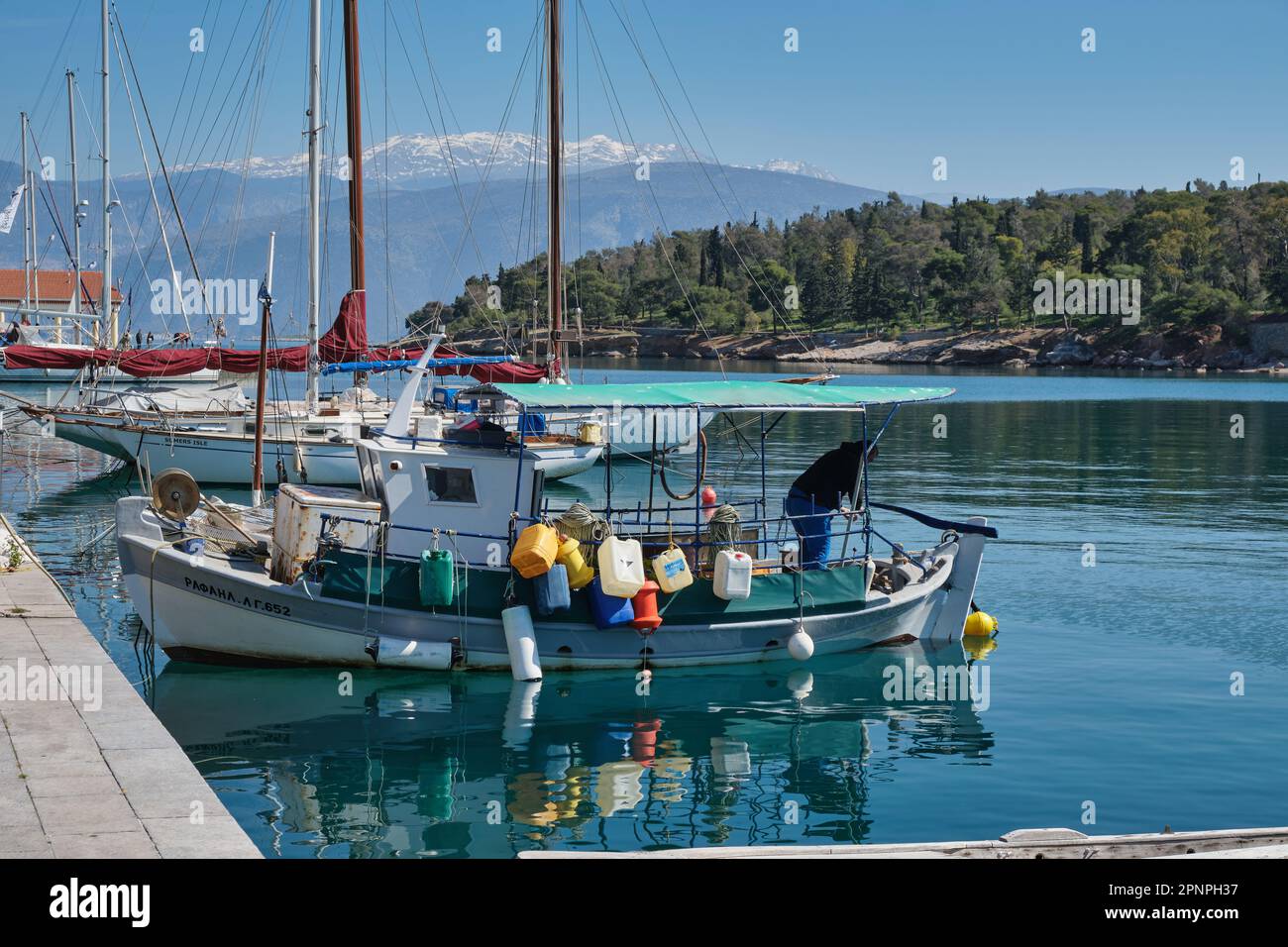 Fisherman mooring his boat in Galaxidi in Greece in Spring Stock Photo ...