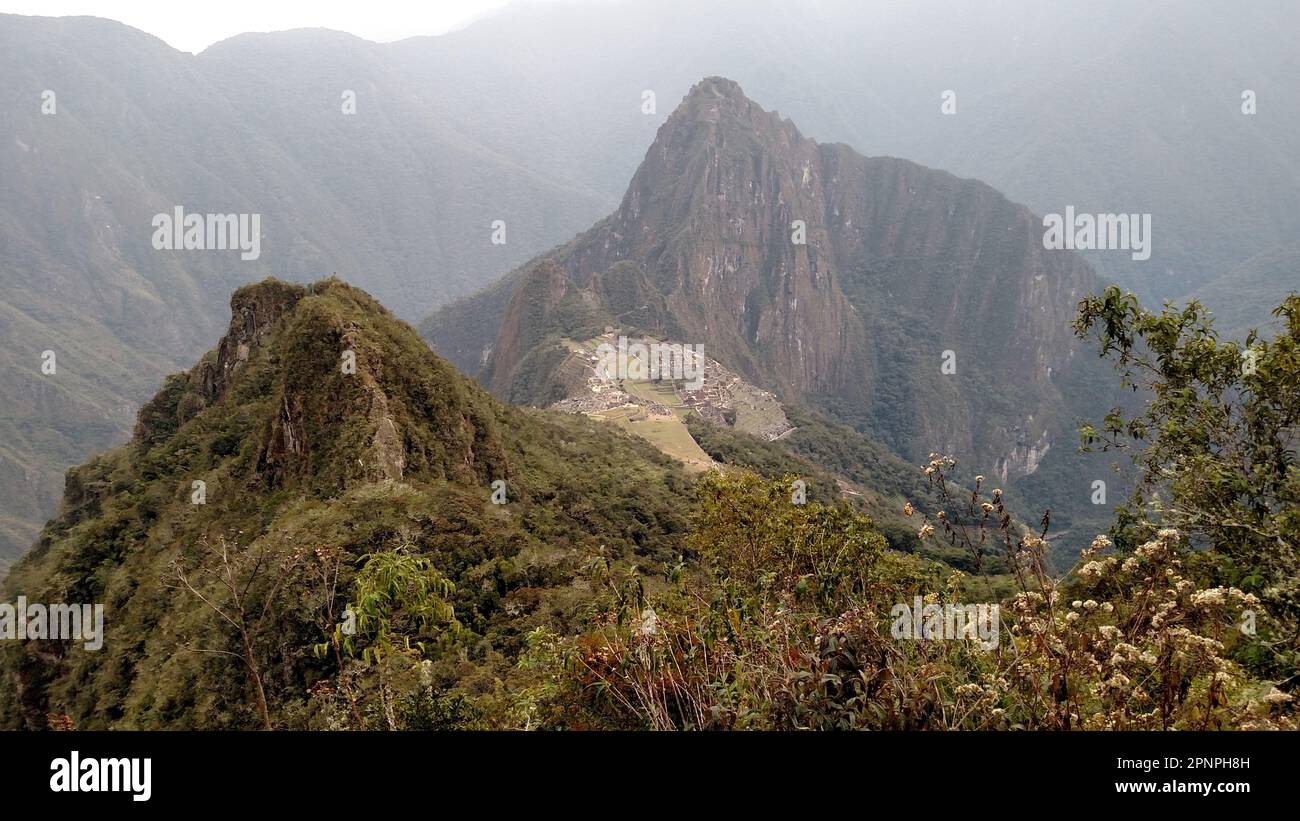 A breathtaking landscape of a tall mountain range featuring a steep ...