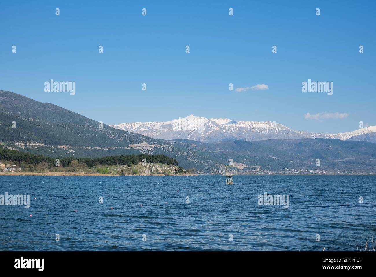View of the Ioannina Lake in Greece in Spring with the Pindus Mountains ...