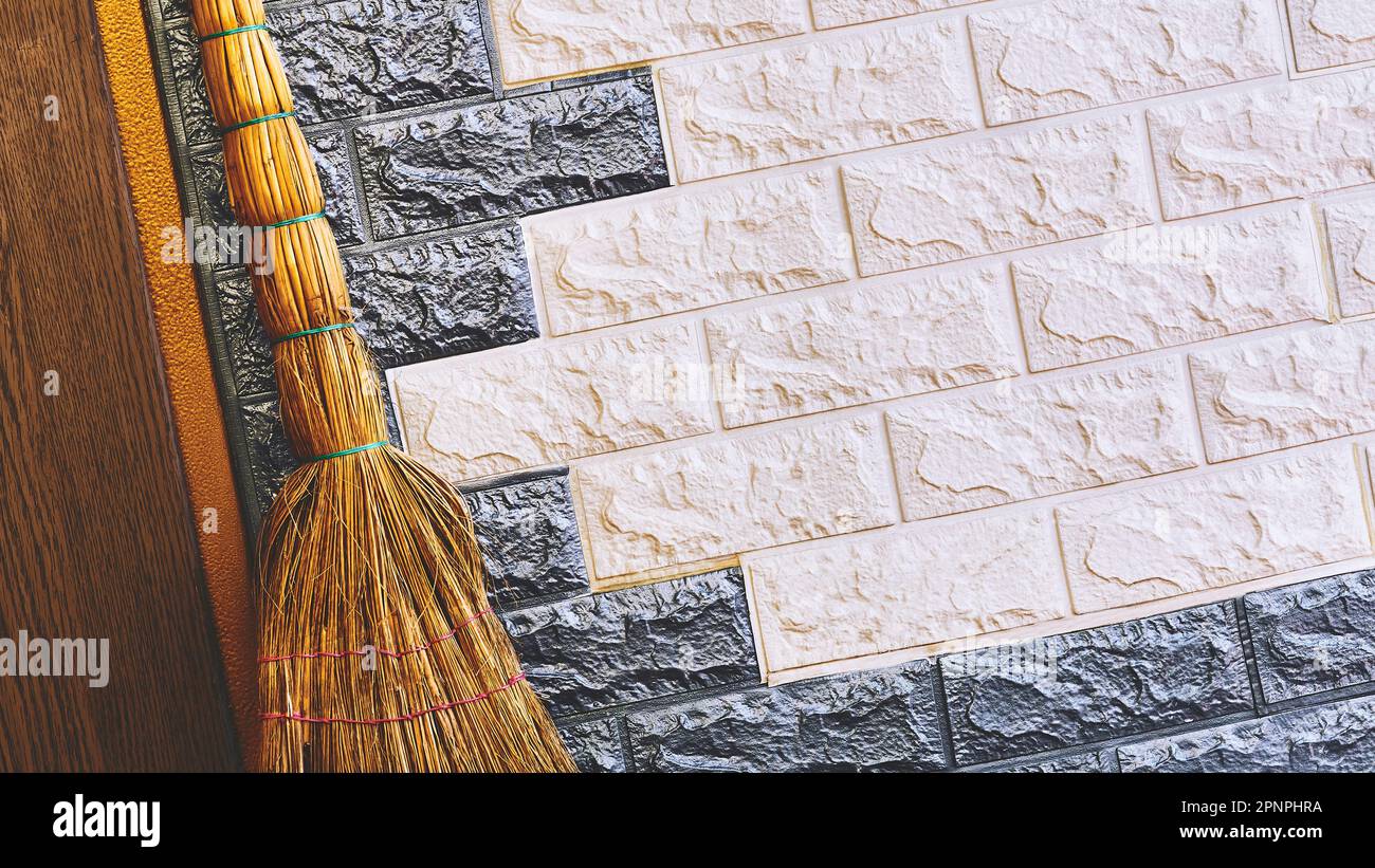 Reed broom for sweeping and cleaning near the wall with plastic ...