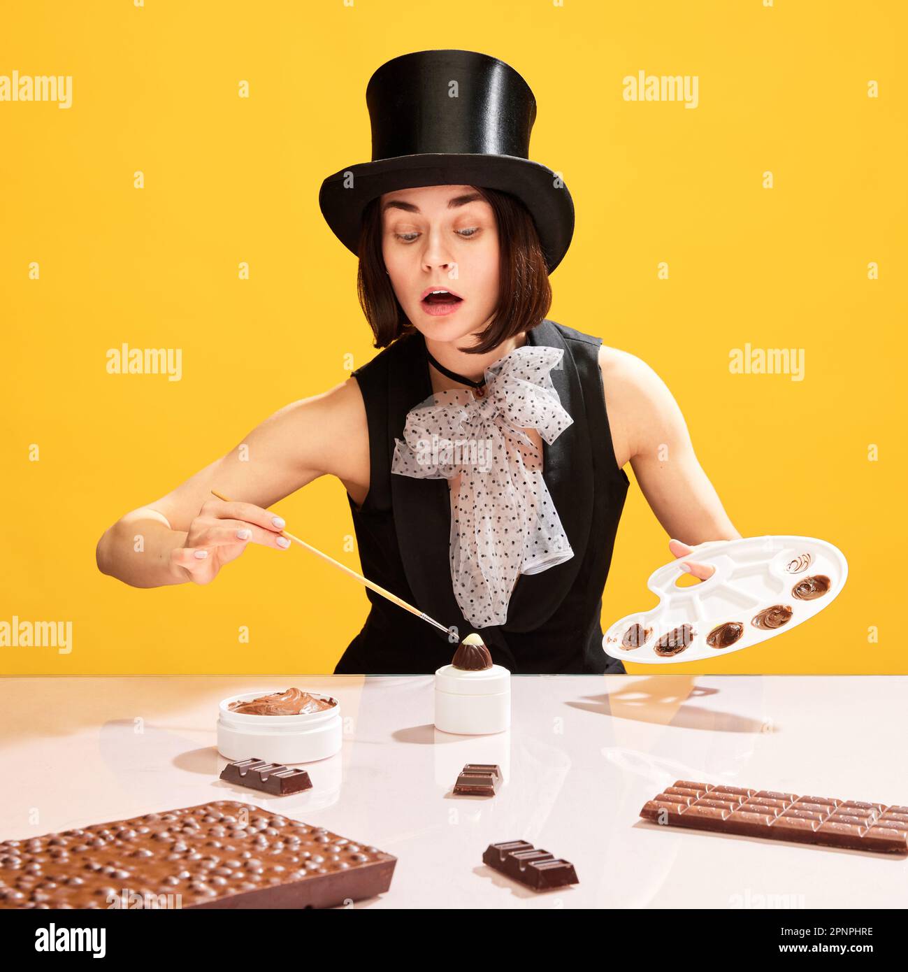 Woman, in image of food painter, in cylinder hat making chocolate ...