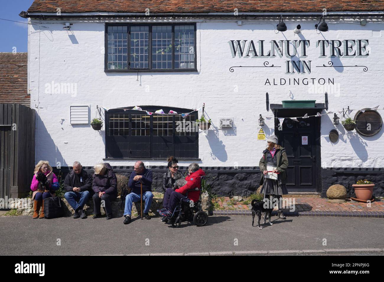 Well wishers wait outside the Walnut Tree Pub in Aldington, Kent, for ...