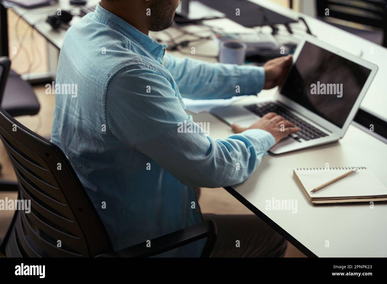 Male adjusting computer before work in the office Stock Photo - Alamy