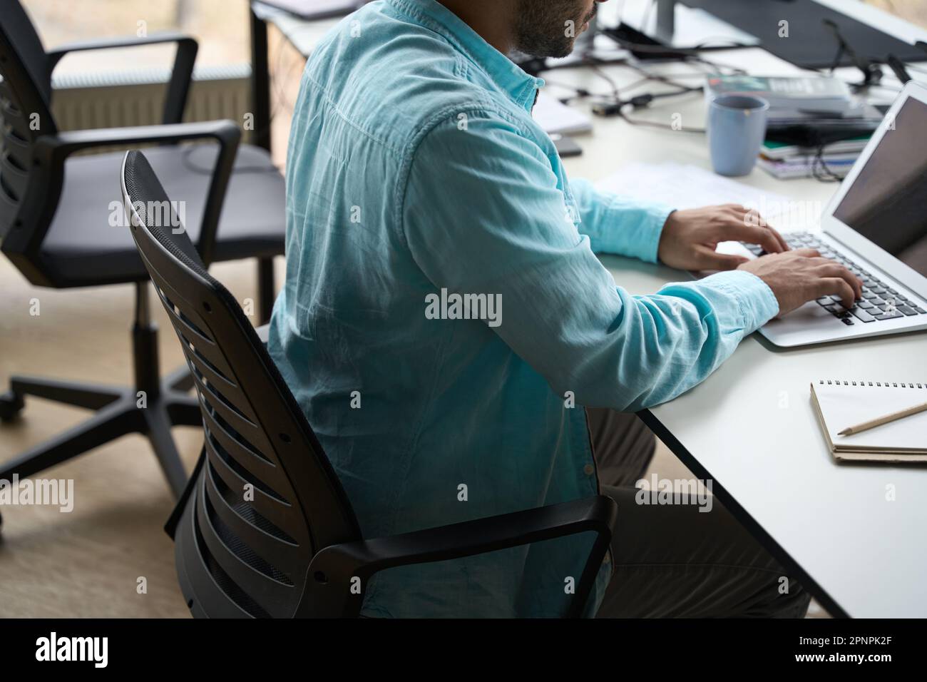 Man entering data into laptop at work Stock Photo - Alamy