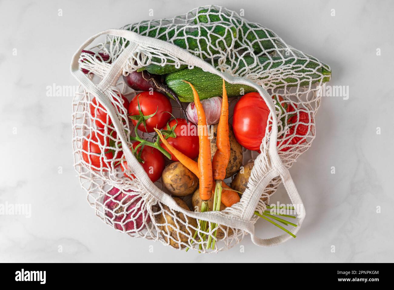 Organic vegetables in reusable shopping mesh bag or string bag from the ...