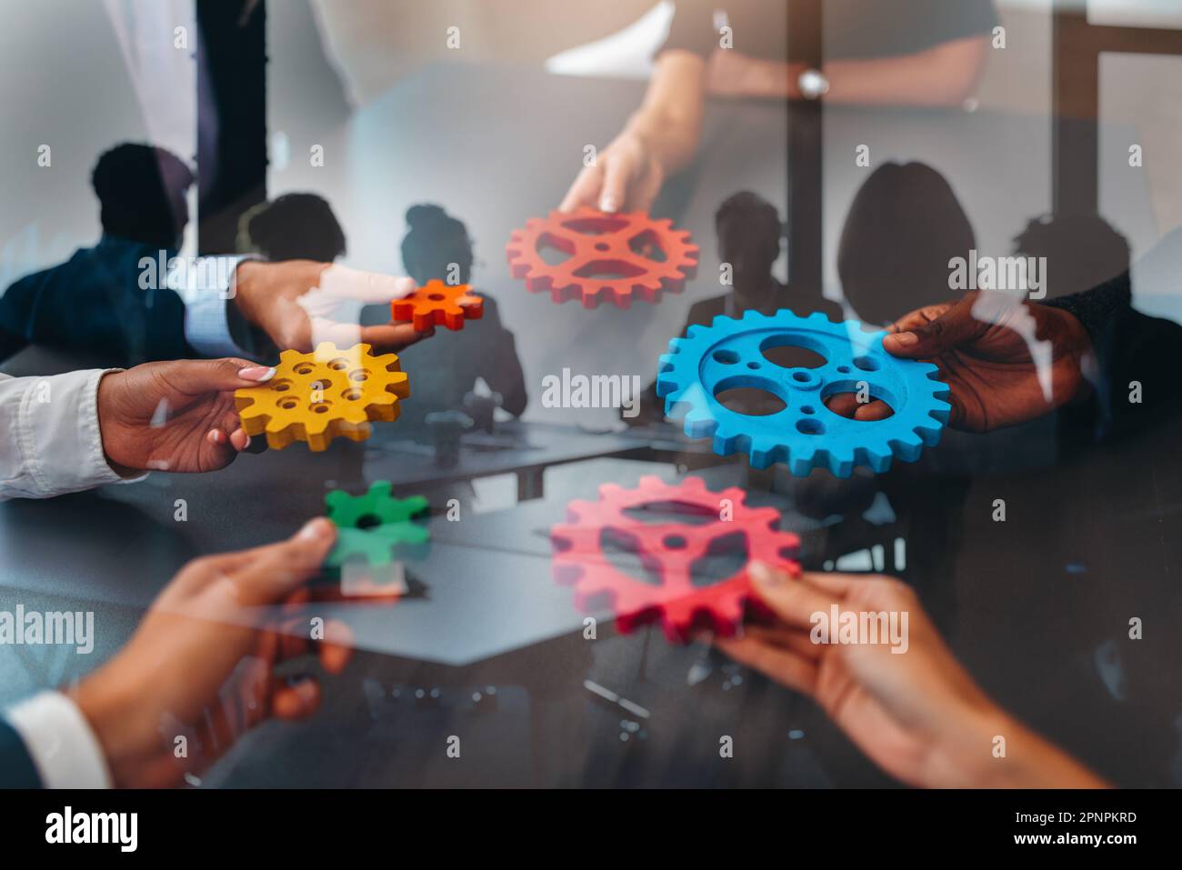 Businessteam work together and combine pieces of gears. Partnership and ...