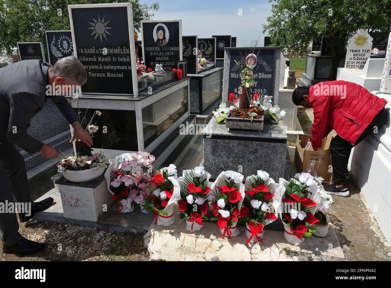 Yazidis visit the cemetery after performing their prayers at sunrise ...