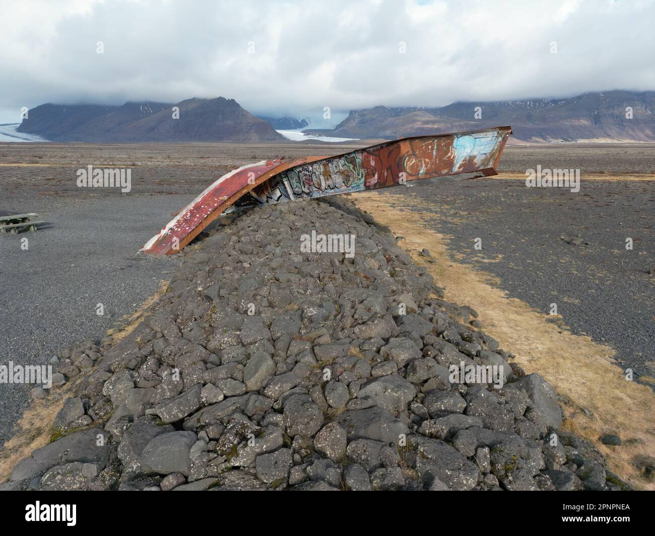 An aerial view of a desolate desert landscape with Skeidara Bridge ...