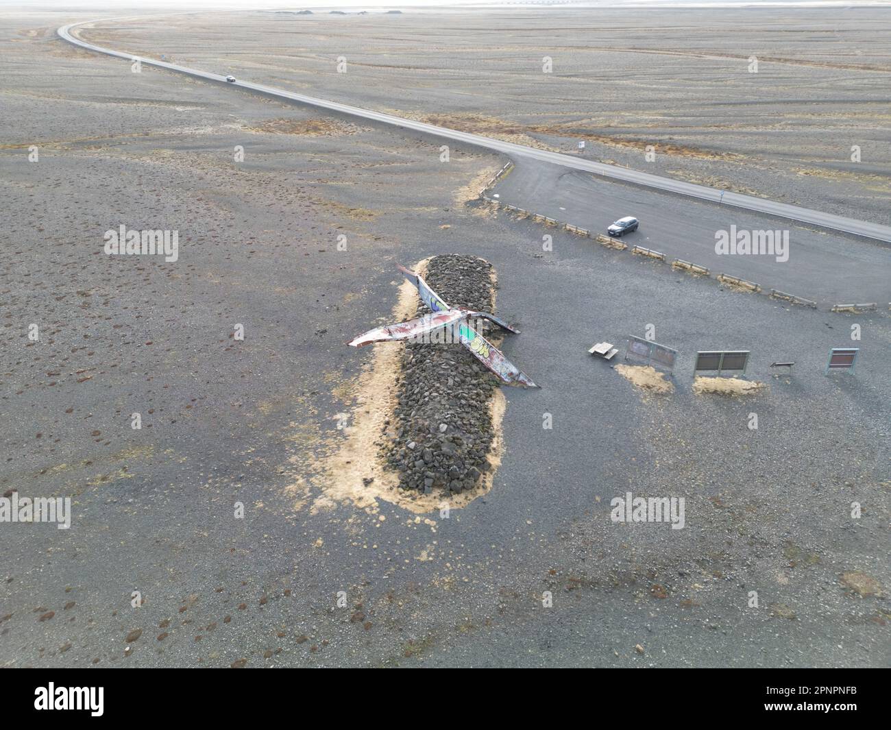 An aerial view of a desolate desert landscape with Skeidara Bridge ...