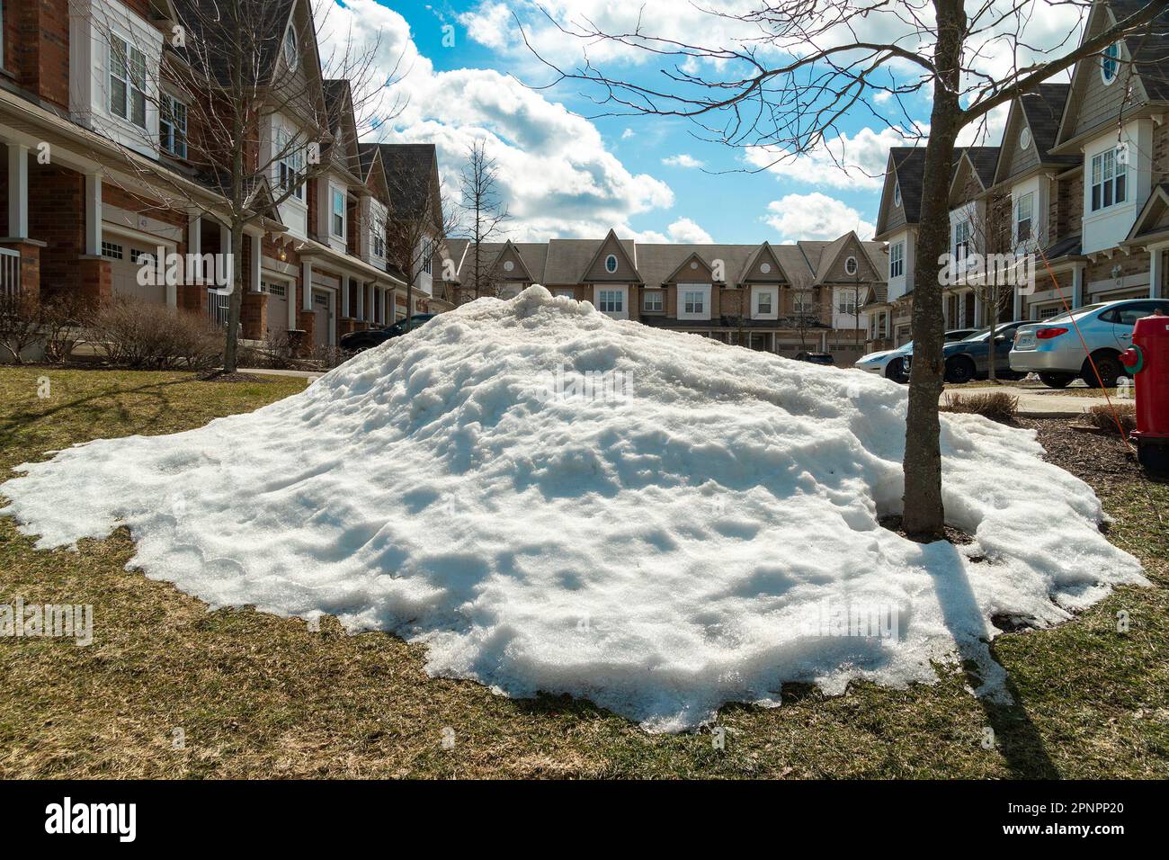 Warm, spring rain gradually washes away the last snow in the city Stock ...