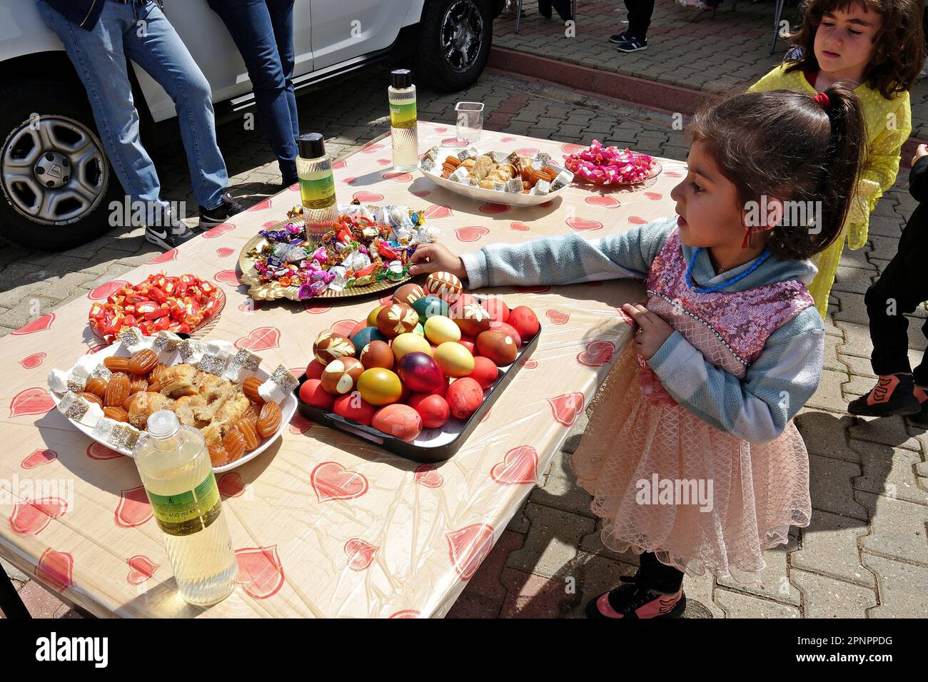 A child takes sweets served during the Eid celebration in the village ...