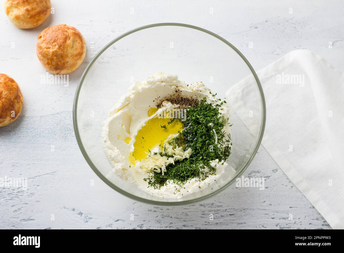 Cooking stuffing for homemade cheese gougères from cream cheese, olive ...