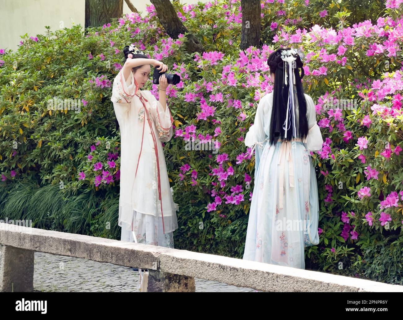 Tourists visit the Humble Administrator's Garden wearing traditional ...