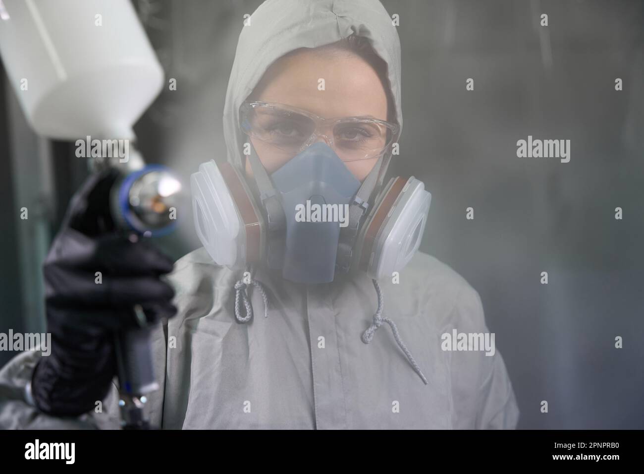 Young woman spray painting car hi-res stock photography and images - Alamy