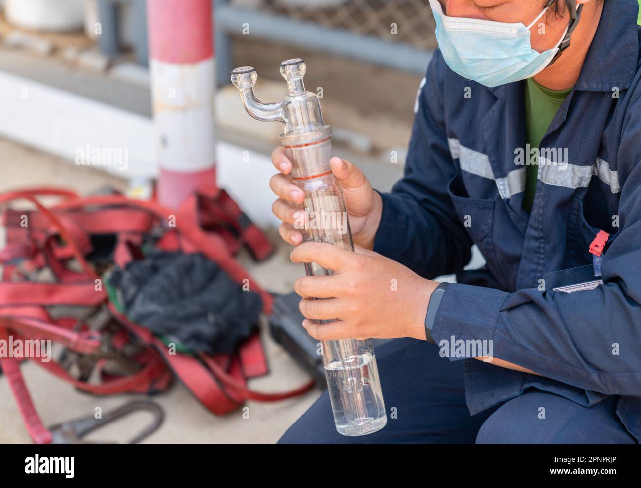 Environment officer setting test tube for sampling stack of boiler in ...