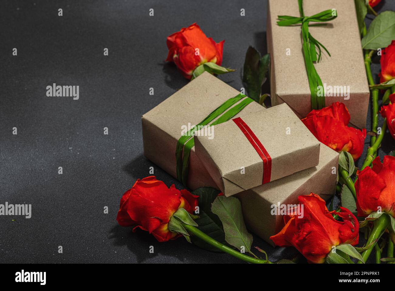 Zero waste gift concept. Bright roses, wrapped in craft paper surprise ...