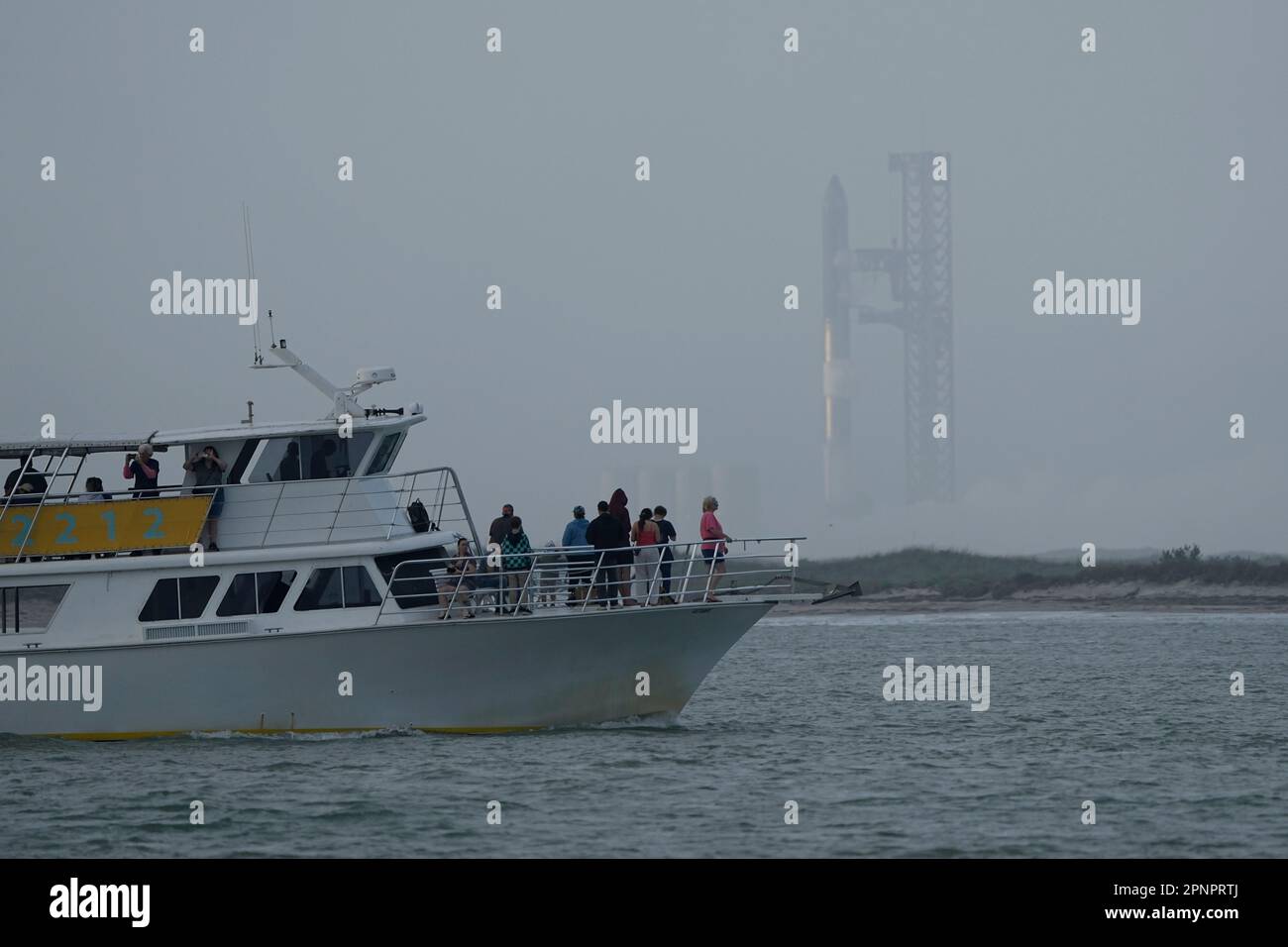A tour boat passes SpaceX's Starship, the world's biggest and most ...