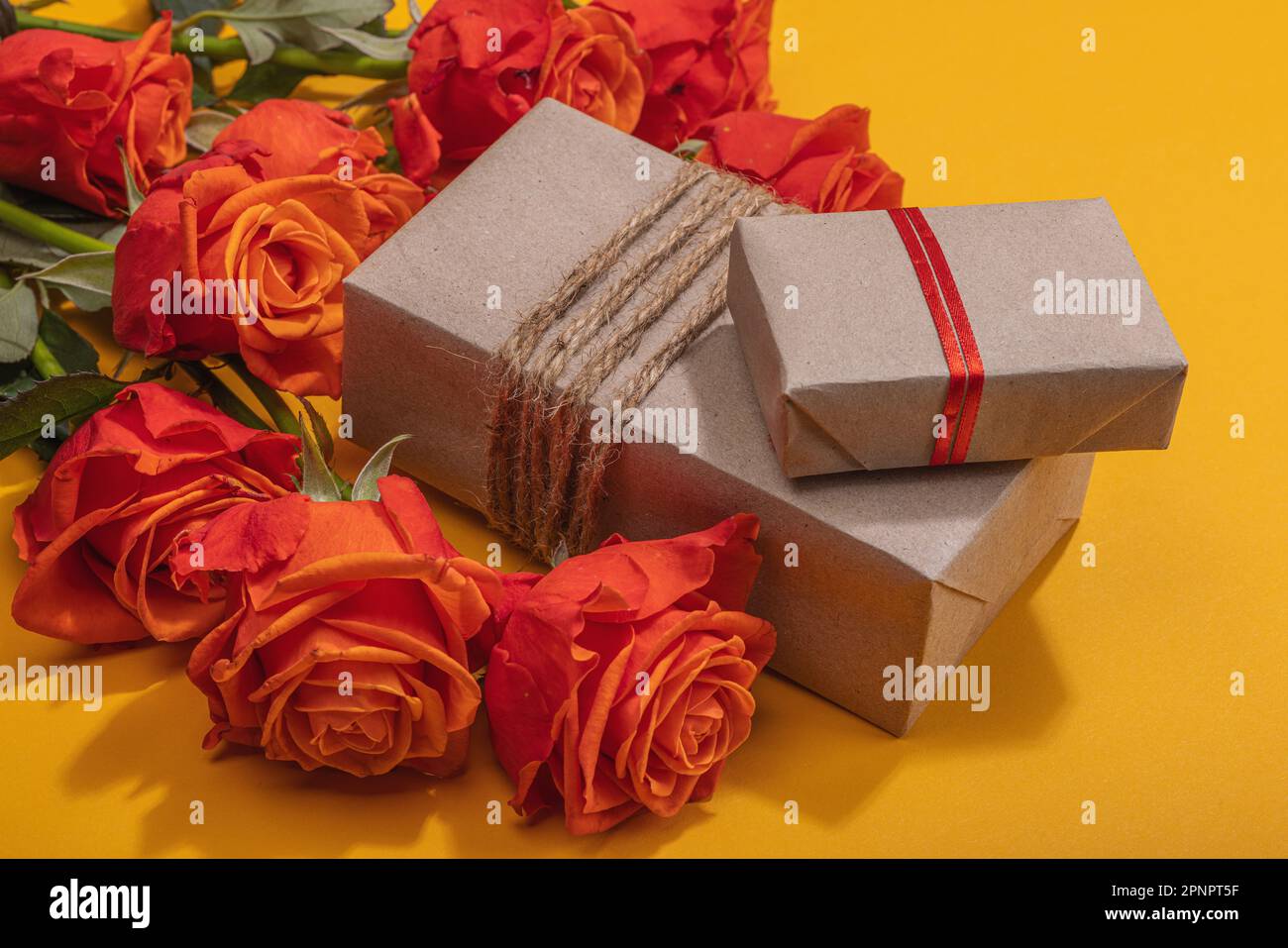 Zero waste gift concept. Bright roses, wrapped in craft paper surprise ...